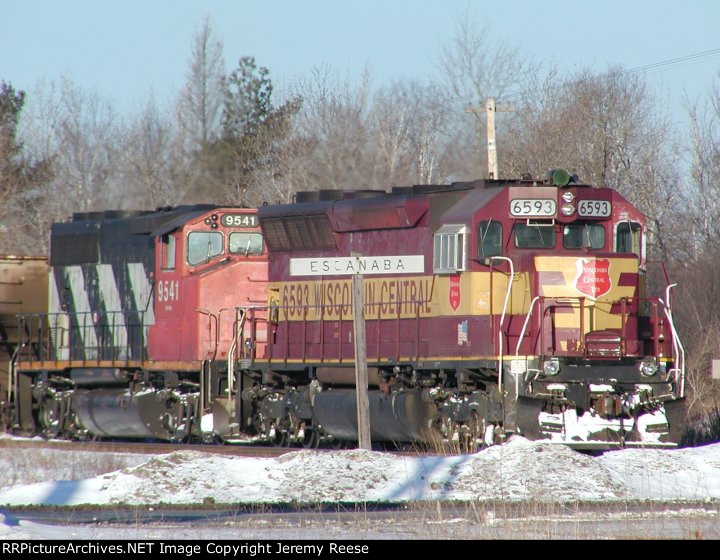 WC 6593 at vhe Escanaba Station Board by N 30th St. in Escanaba
